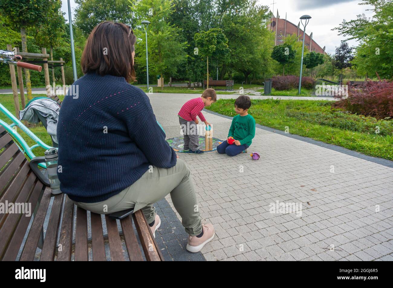 POZNAN, POLAND - Aug 29, 2021: A Woman watching two kids playing with a ...