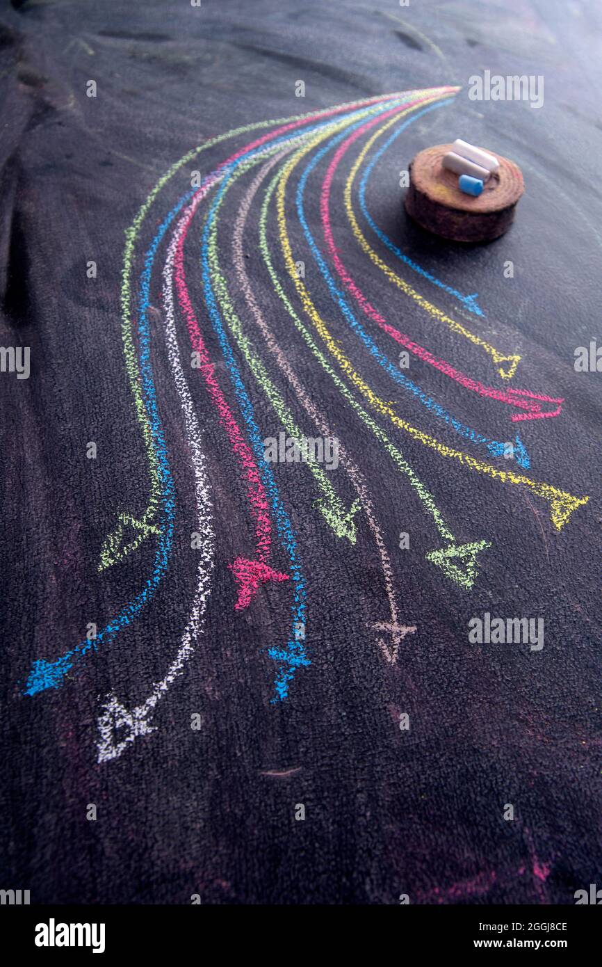 Curved colored arrows drawn with chalk on blackboard Stock Photo - Alamy