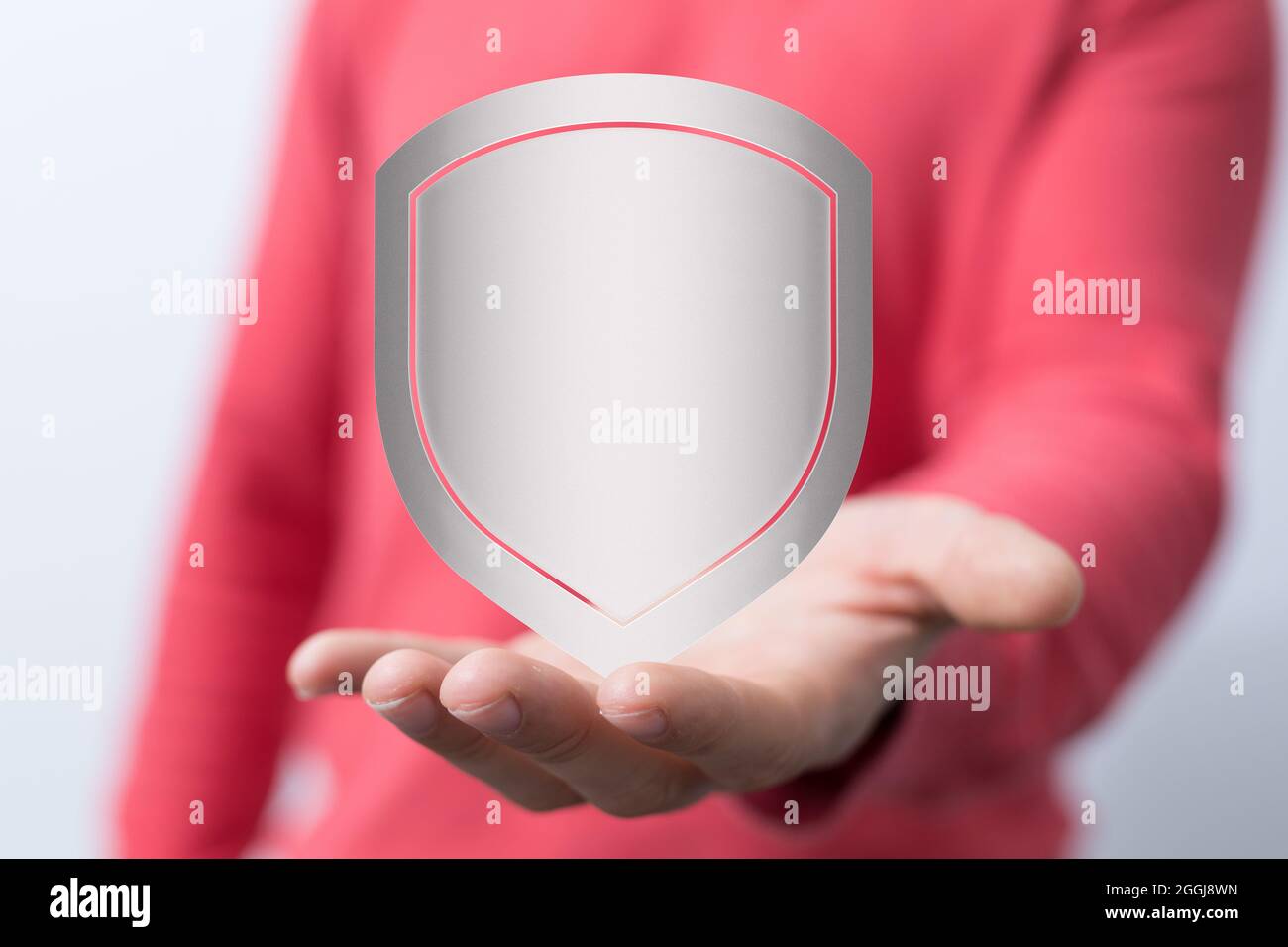Shield protection concept holding in hand Stock Photo - Alamy
