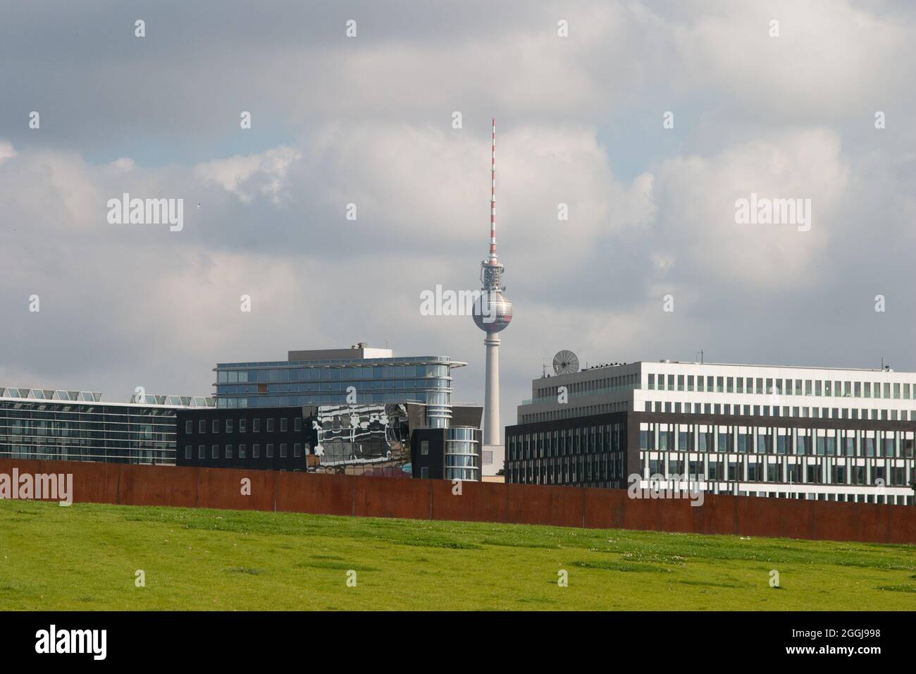The iconic TV tower of Berlin seen amongst modern buildings and a ...