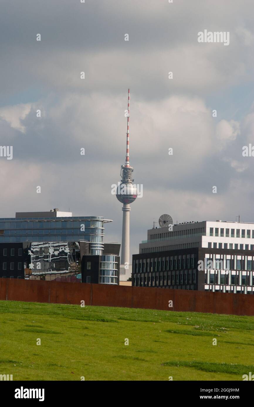 The iconic TV tower of Berlin seen amongst modern buildings and a ...