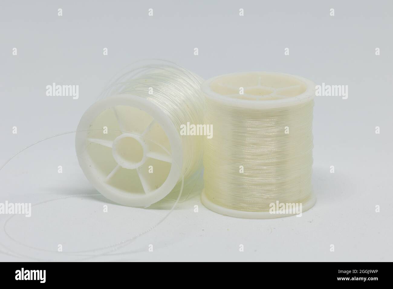 Closeup of cream threads on white background Stock Photo - Alamy