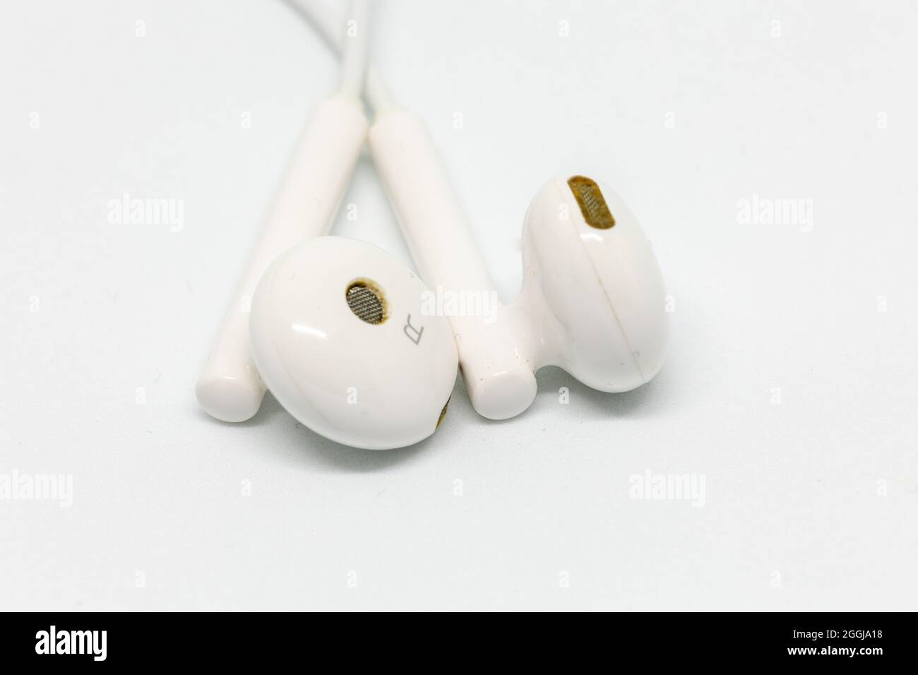 Closeup of white earphones on white background Stock Photo - Alamy