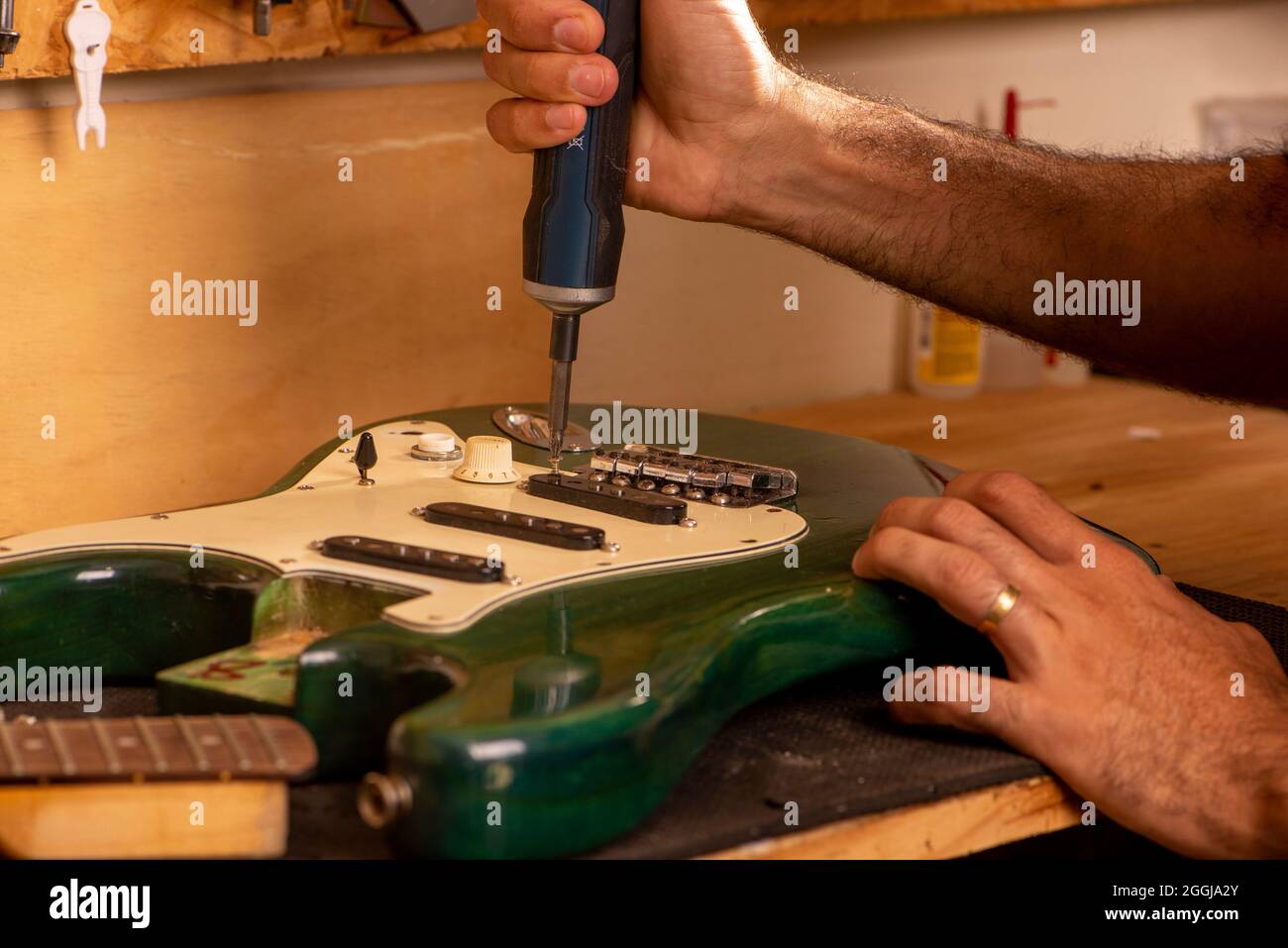 man's hands working on repairing a electric guitar Stock Photo - Alamy