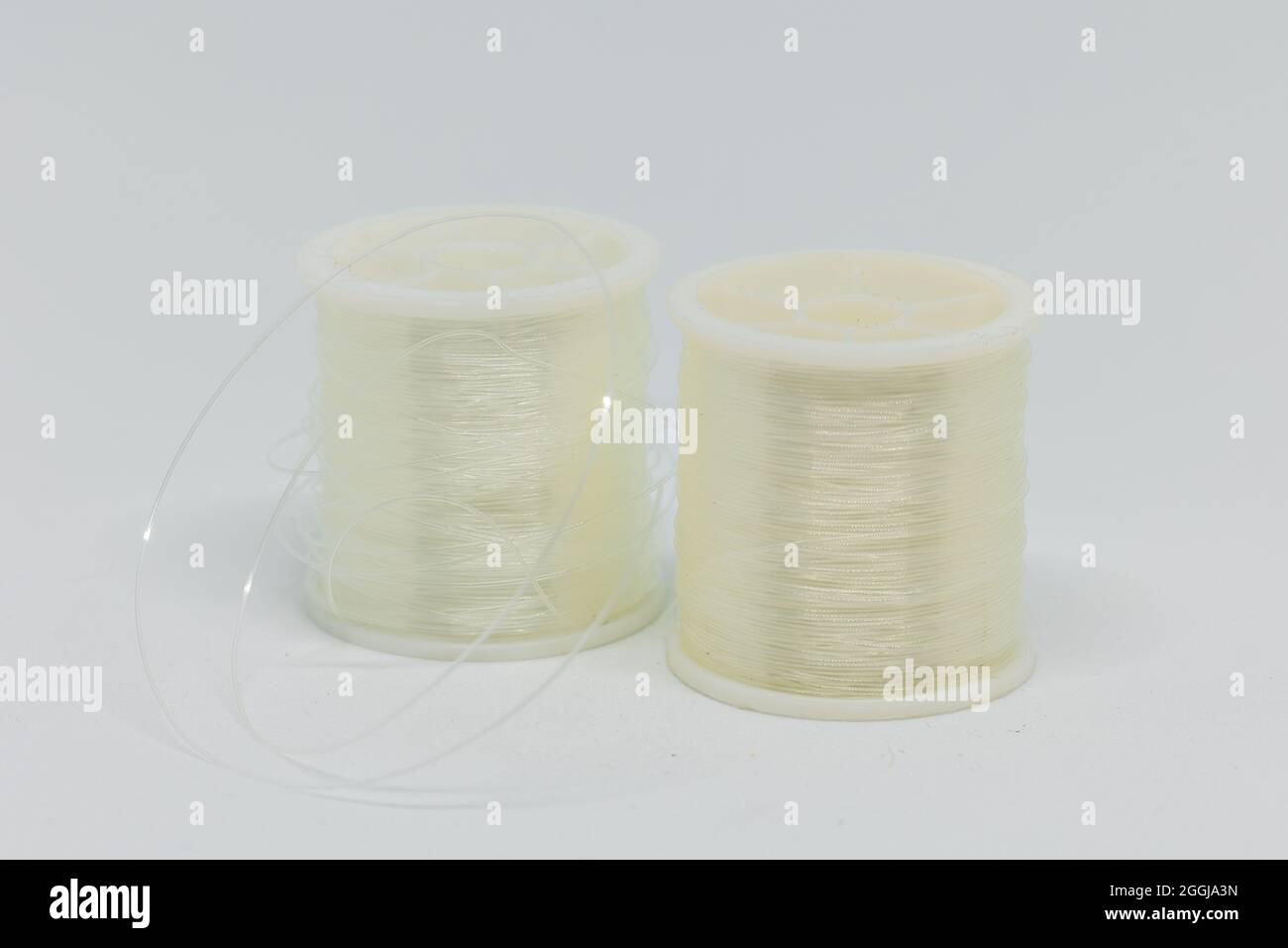 Closeup of cream threads on white background Stock Photo - Alamy