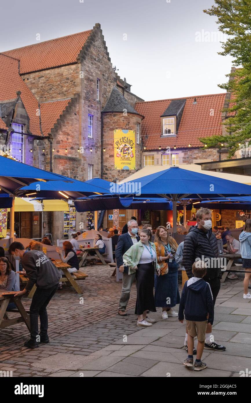 People drinking and eating street food in the Pleasance Courtyard venue ...