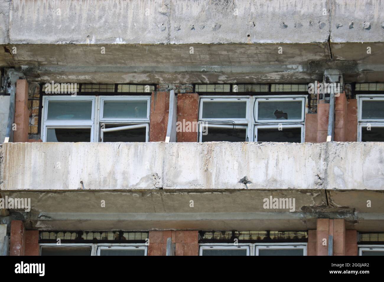 Abandoned crumbling building with semicircular balconies - danger of ...
