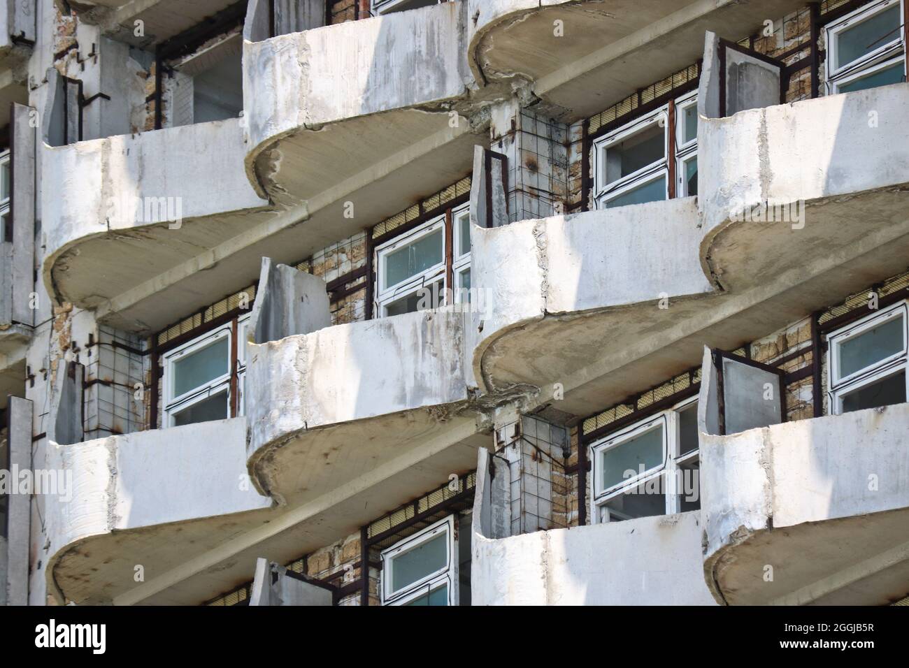 Abandoned crumbling building with semicircular balconies - danger of ...