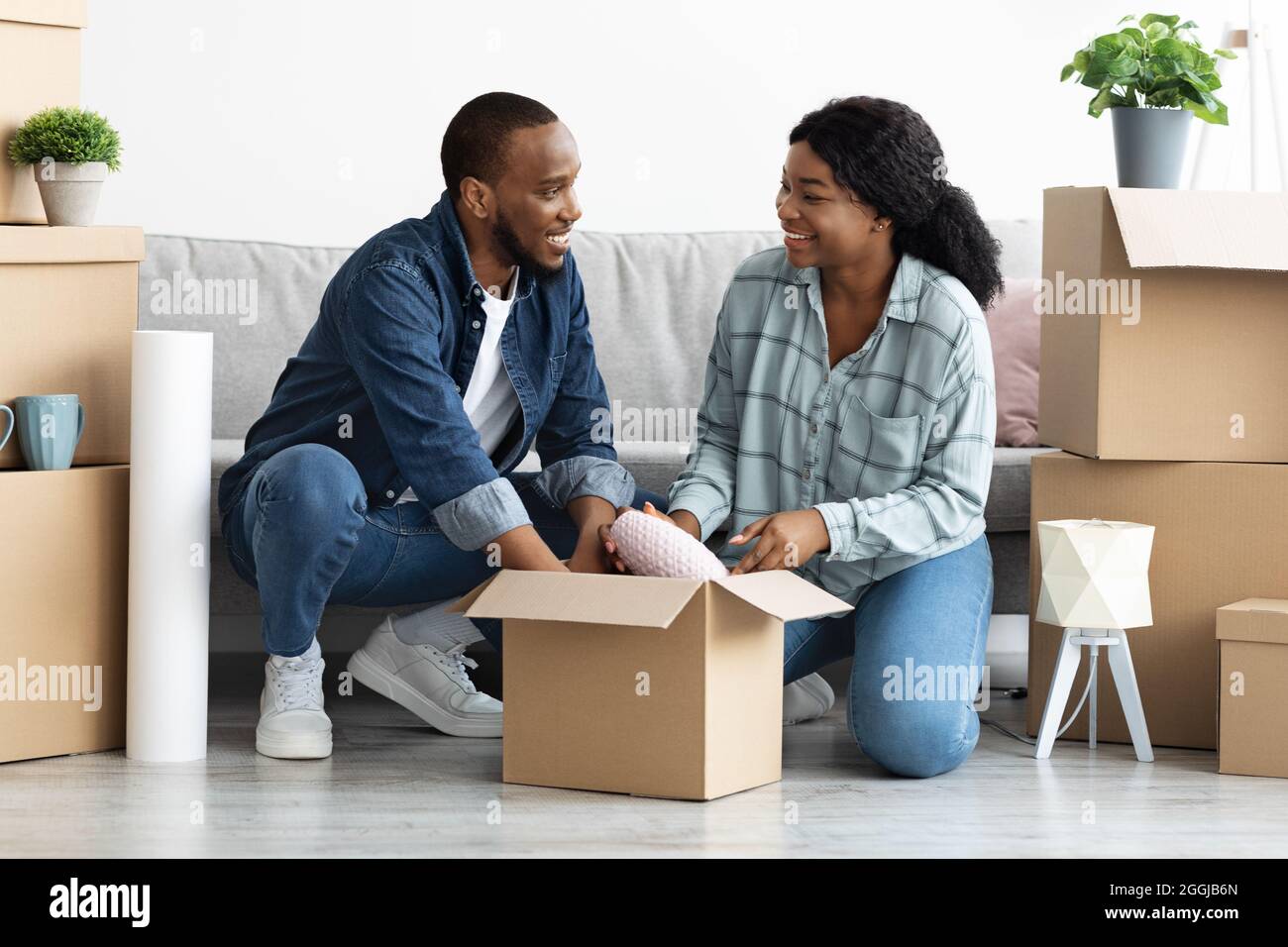 Moving To New House. Happy African-American Spouses Packing Belongings ...