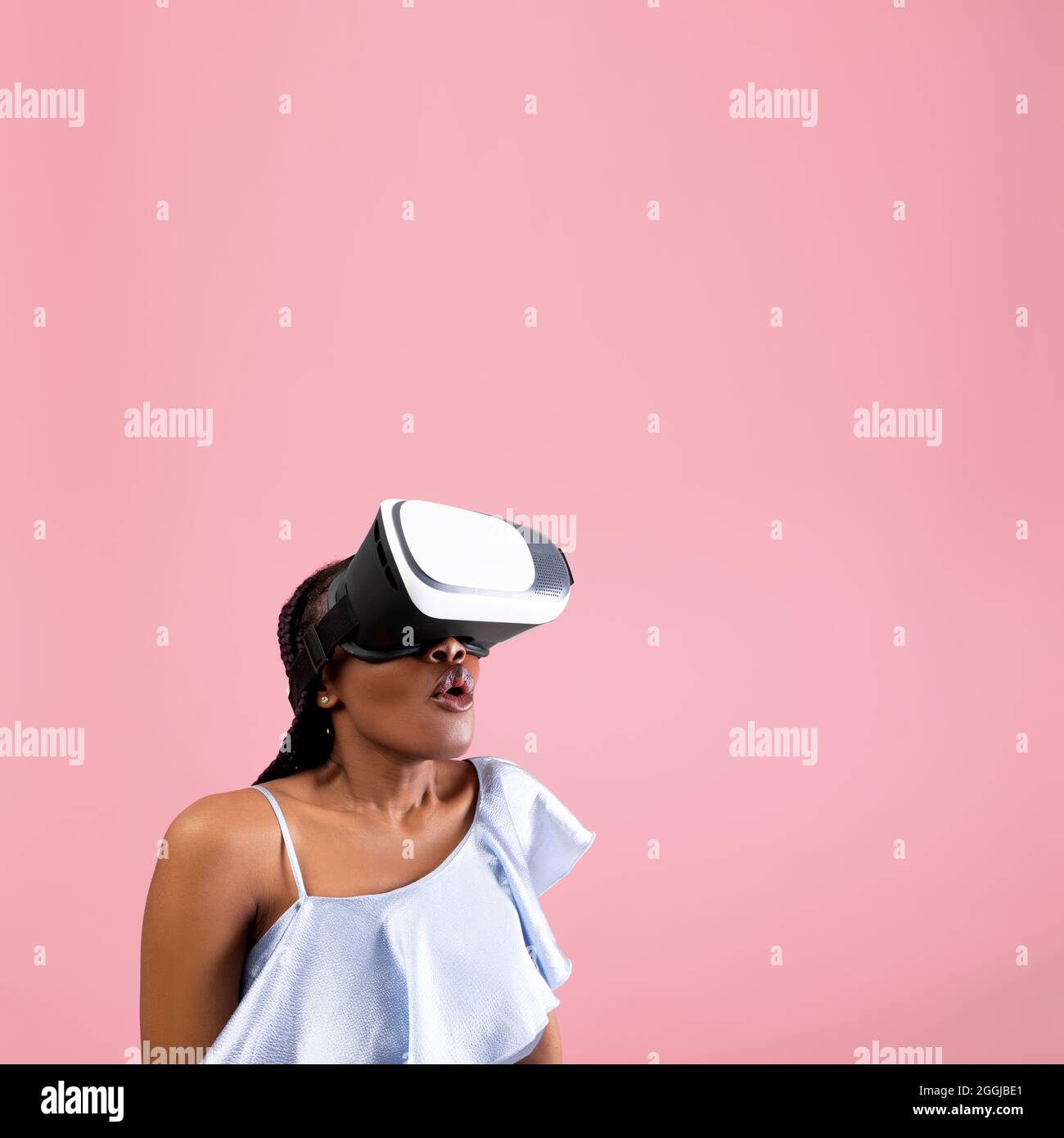 Cyberspace. Shocked African American woman wearing VR helmet ...