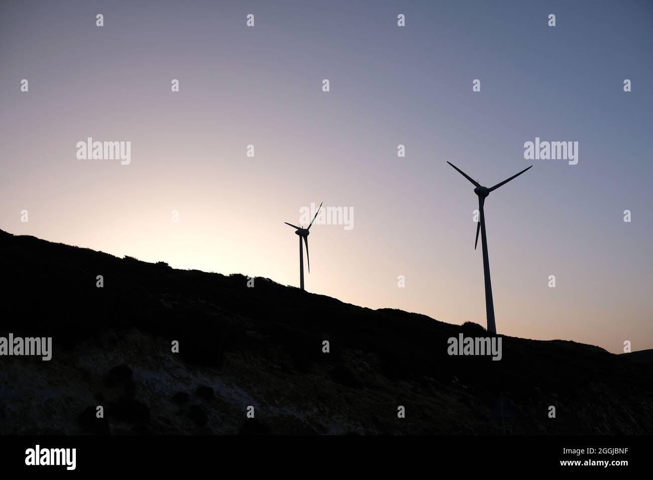 View of two massive wind turbines producing energy for the island of ...
