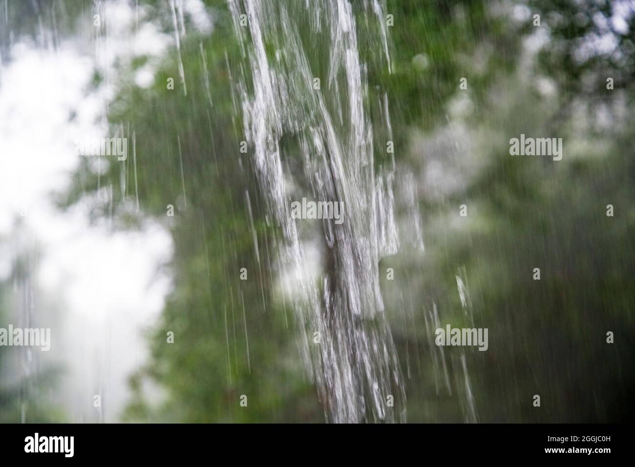 Intense rain pours off the roof of a home in North Central Florida ...
