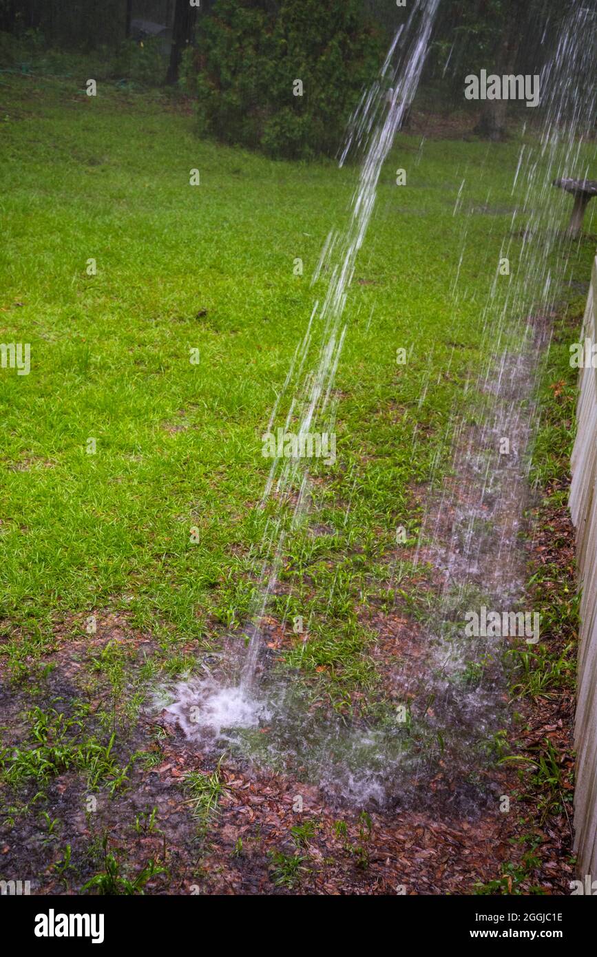 Intense rain pours off the roof of a home in North Central Florida ...