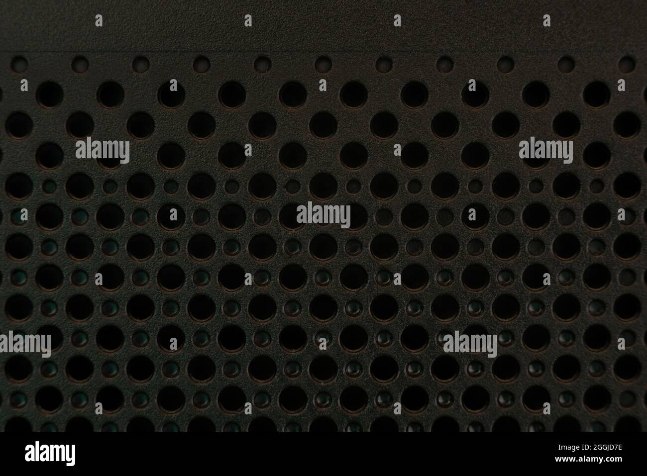 Dark colored surface with holes of different sizes Stock Photo - Alamy