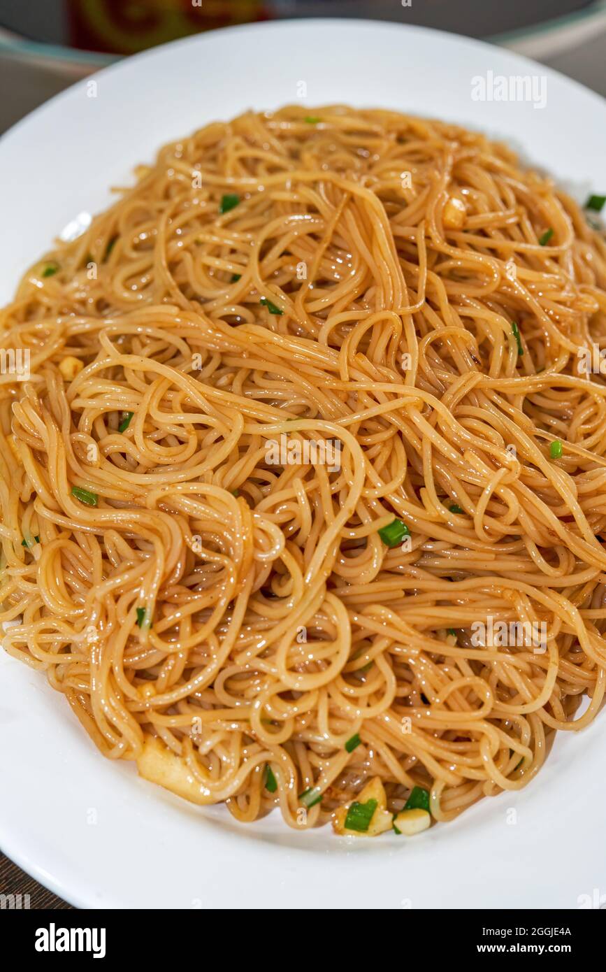 A delicious Chinese dish, dry fried round rice noodles Stock Photo - Alamy