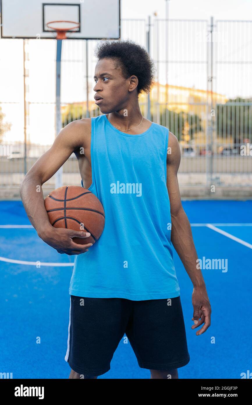 Man holding ball under arm hi-res stock photography and images - Alamy