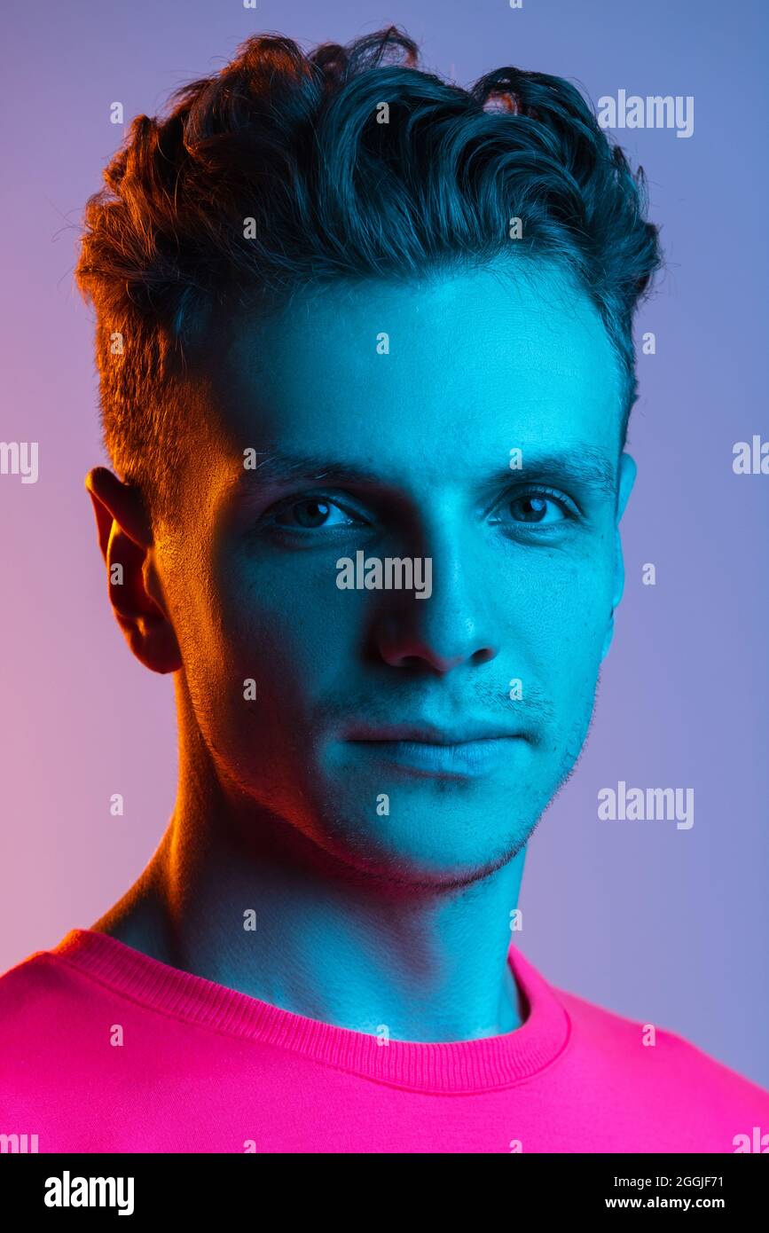 Caucasian young man's portrait isolated on purple color studio ...