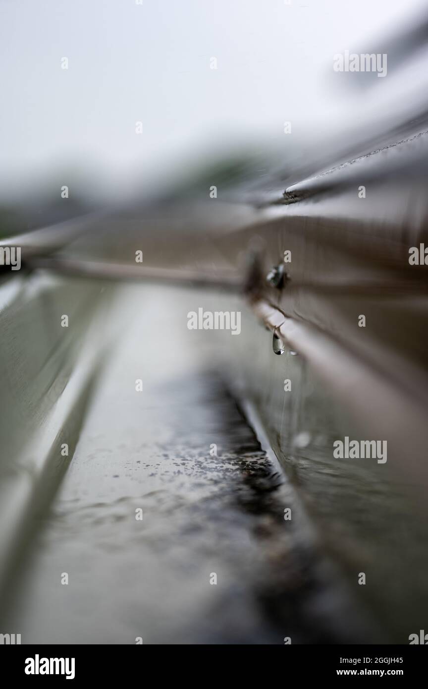 Selective focus on a section of residential guttering with hanger ...