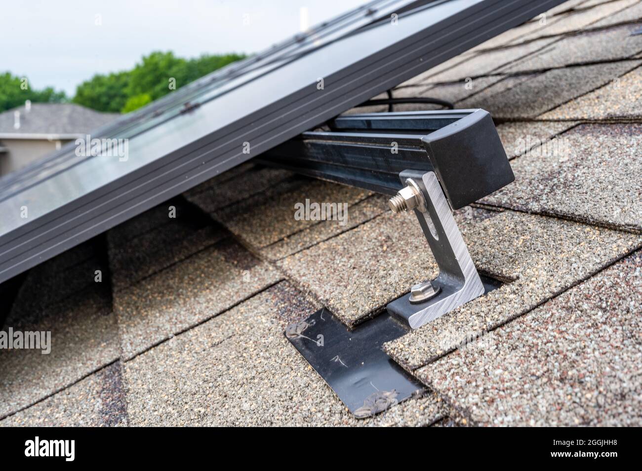 Rail, bracket, and anchor to a solar panel installed on a asphalt ...