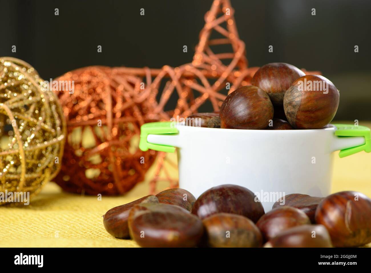 portuguese nuts in ceramic container over yellow jute and with ...