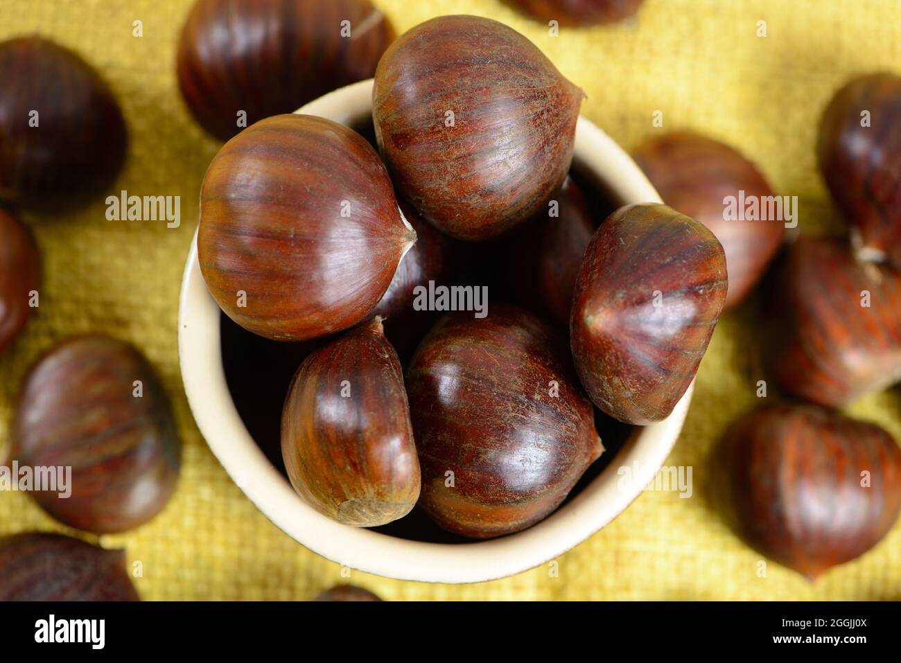 portuguese nuts in ceramic container on table with yellow jute Stock ...