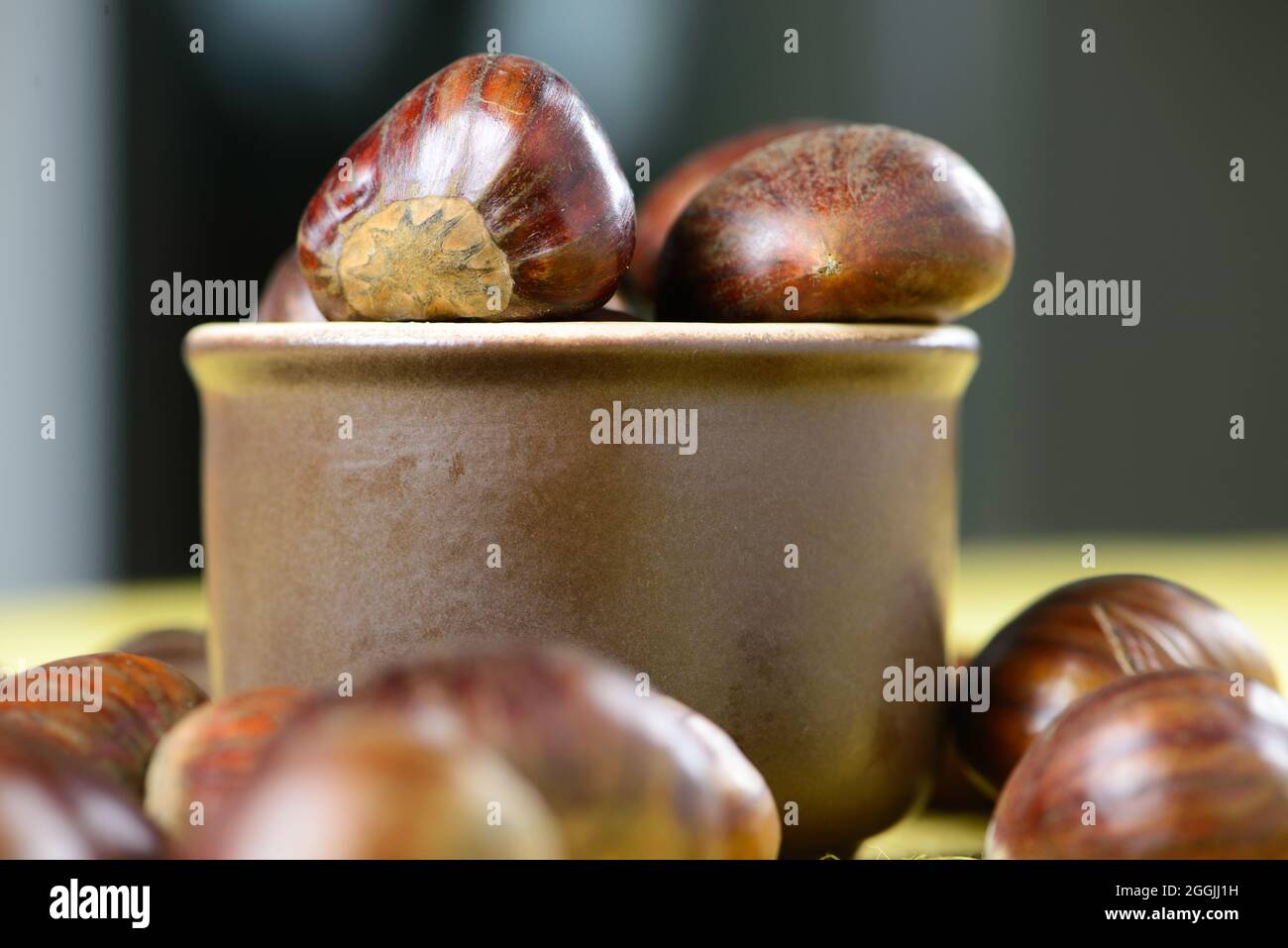 portuguese nuts in ceramic container on table with yellow jute Stock ...