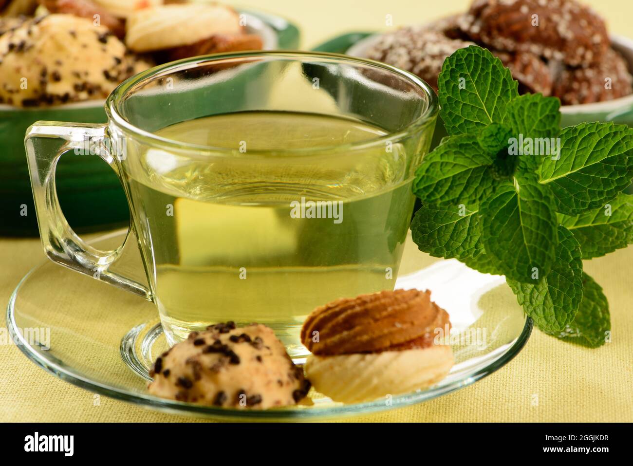mint tea in transparent cup with sweet cookies around Stock Photo - Alamy