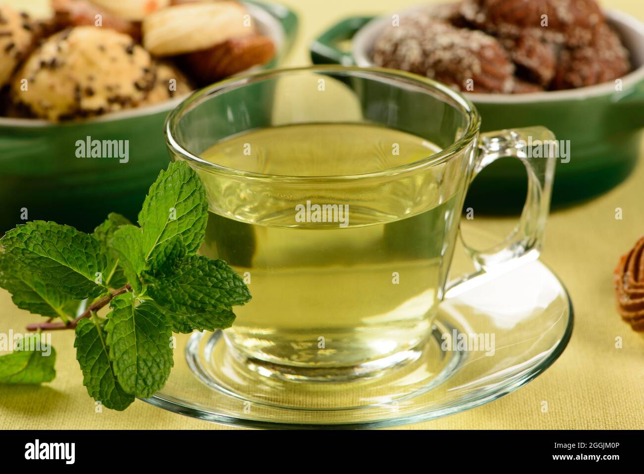 mint tea in transparent cup with sweet cookies around Stock Photo - Alamy