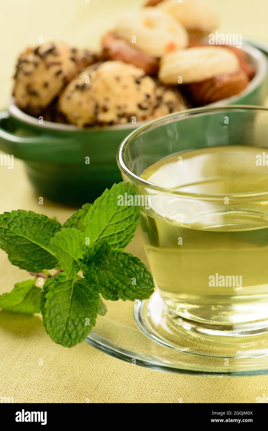 mint tea in transparent cup with sweet cookies around Stock Photo - Alamy