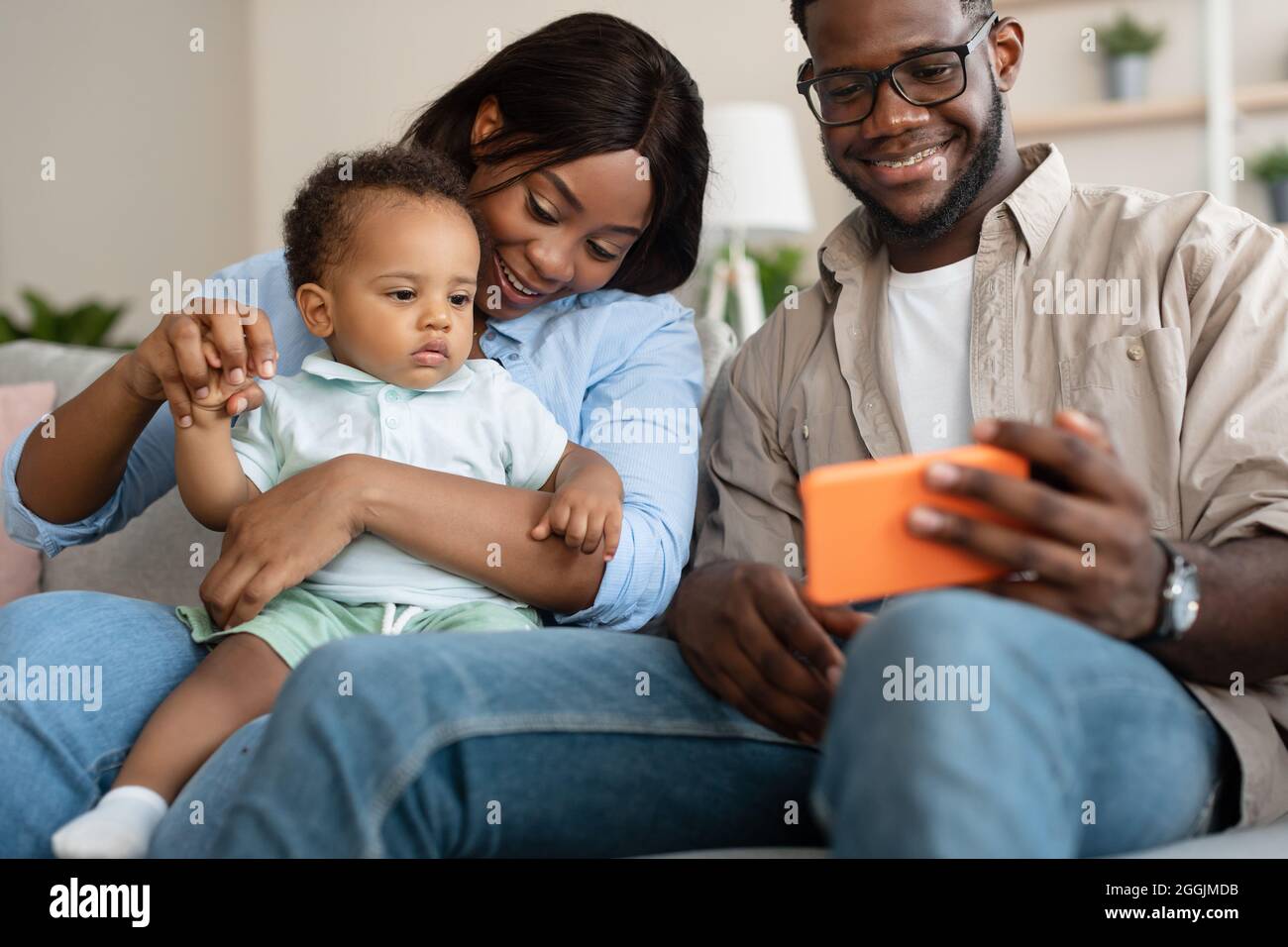 Portrait of african american family using cell phone at home Stock ...