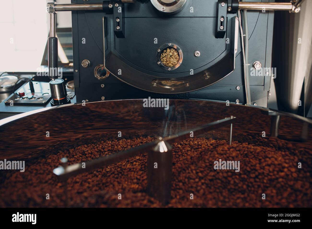Coffee roaster machine at coffee roasting process. Mixing coffee beans ...