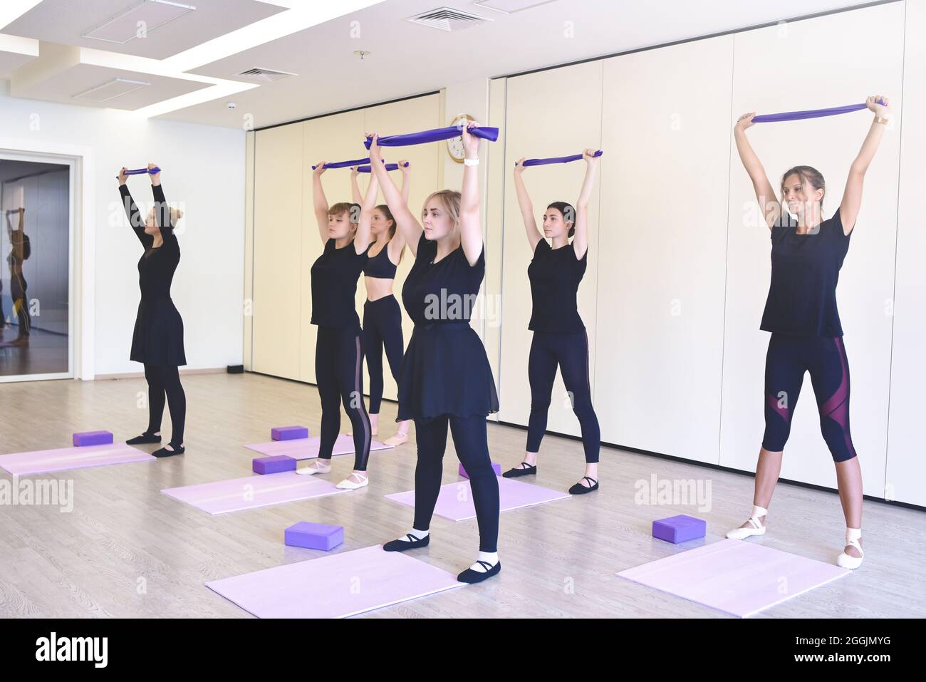 Five dancer girls warming up with stretching exercises for flexibility ...