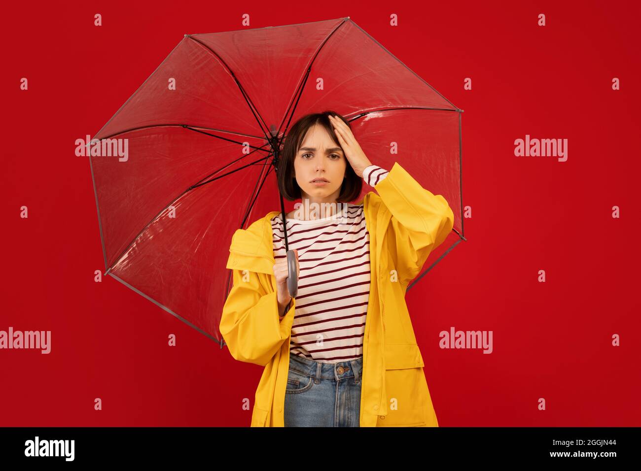 Weather dependence concept. Young woman touching head and standing ...
