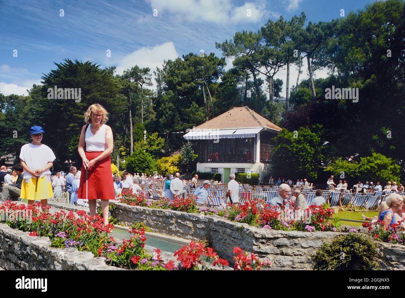 Players on the mini golf course and an audience listening to a concert ...