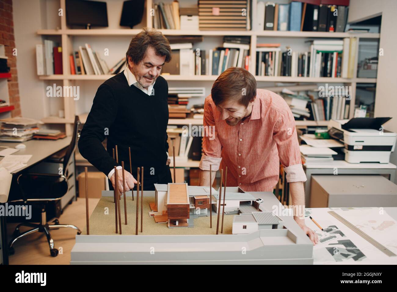 Architects with blueprints and layout design project at office bureau ...