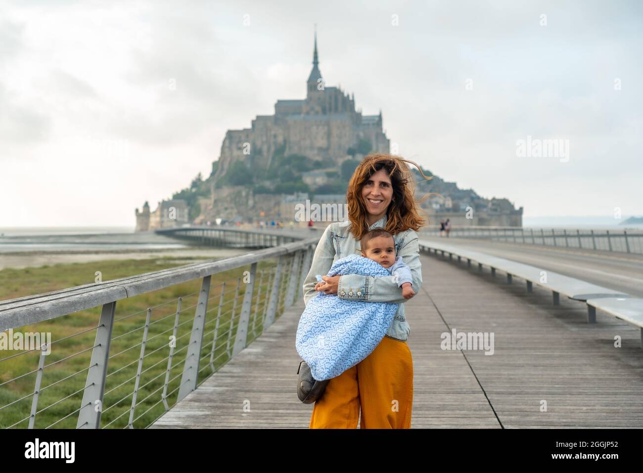 Young mother with her baby visiting the famous Mont Saint-Michel in the ...