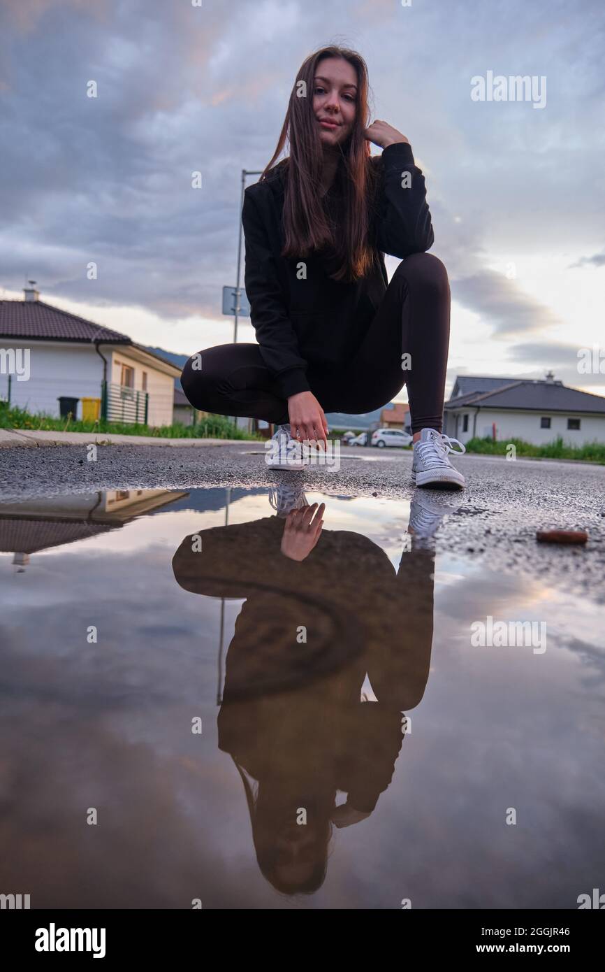 A girl over the puddle Stock Photo - Alamy