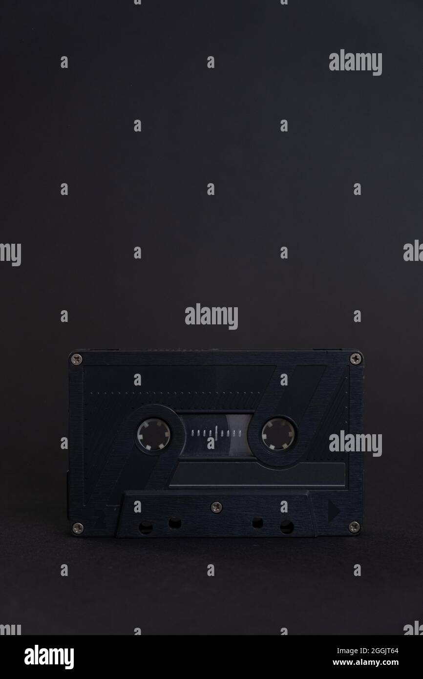 Audio cassette close up, centered on dark grey background. Analog Audio ...