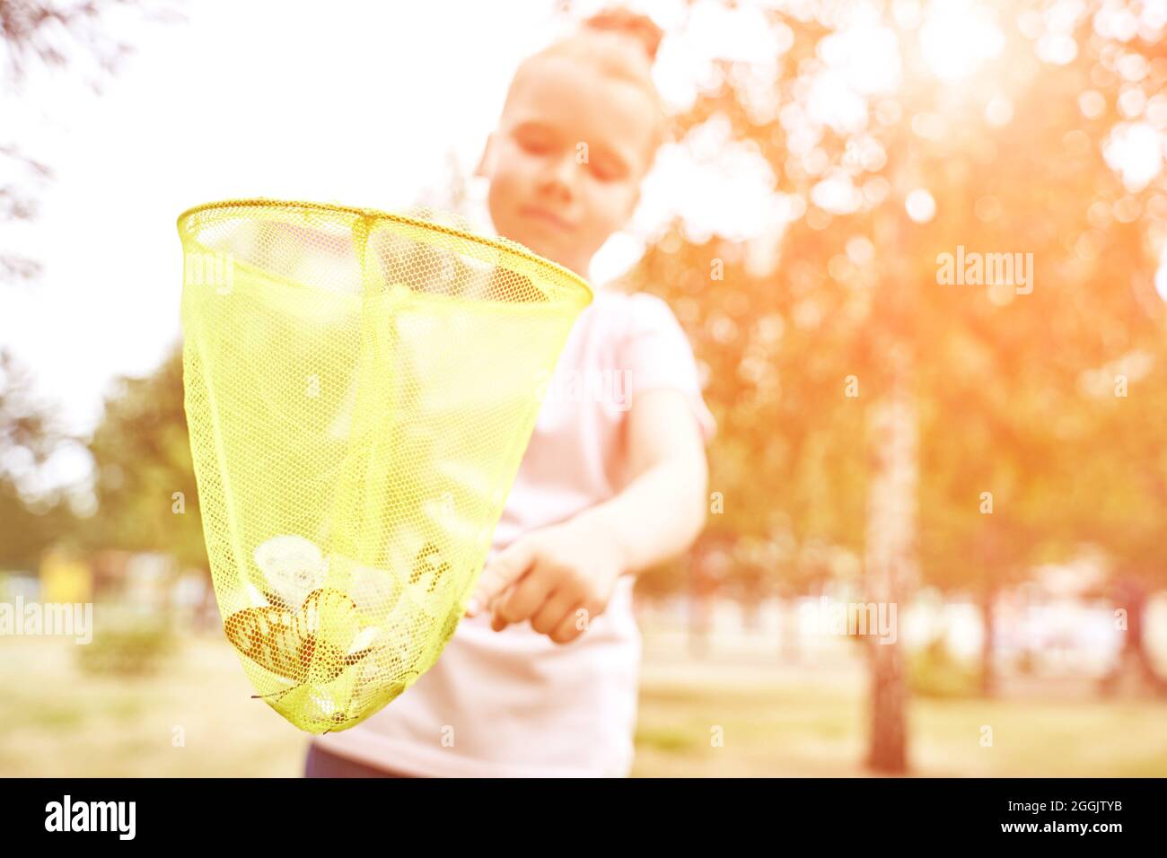 Little girl playing with butterfly net. Summer adventure. Happy toddler ...