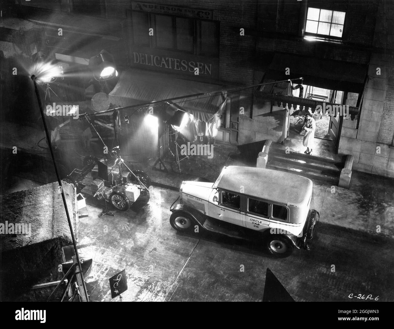 CAROLE LOMBARD on set with Movie Crew sound stage candid filming a rainstorm sequence with Taxi ...