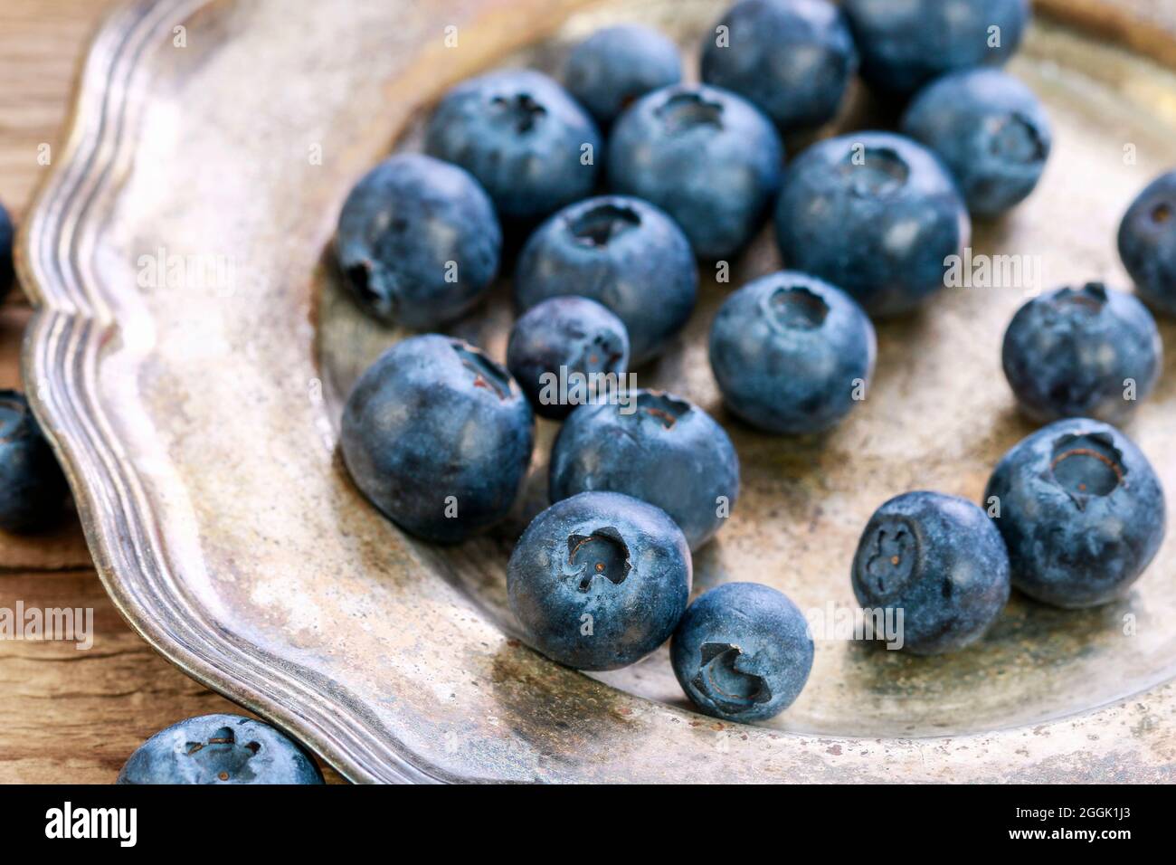 Blueberries on vintage metal plate. Healthy food Stock Photo - Alamy