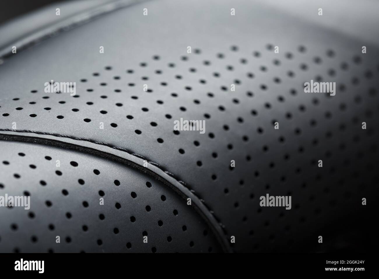Perforated material made of black imitation leather in full screen ...