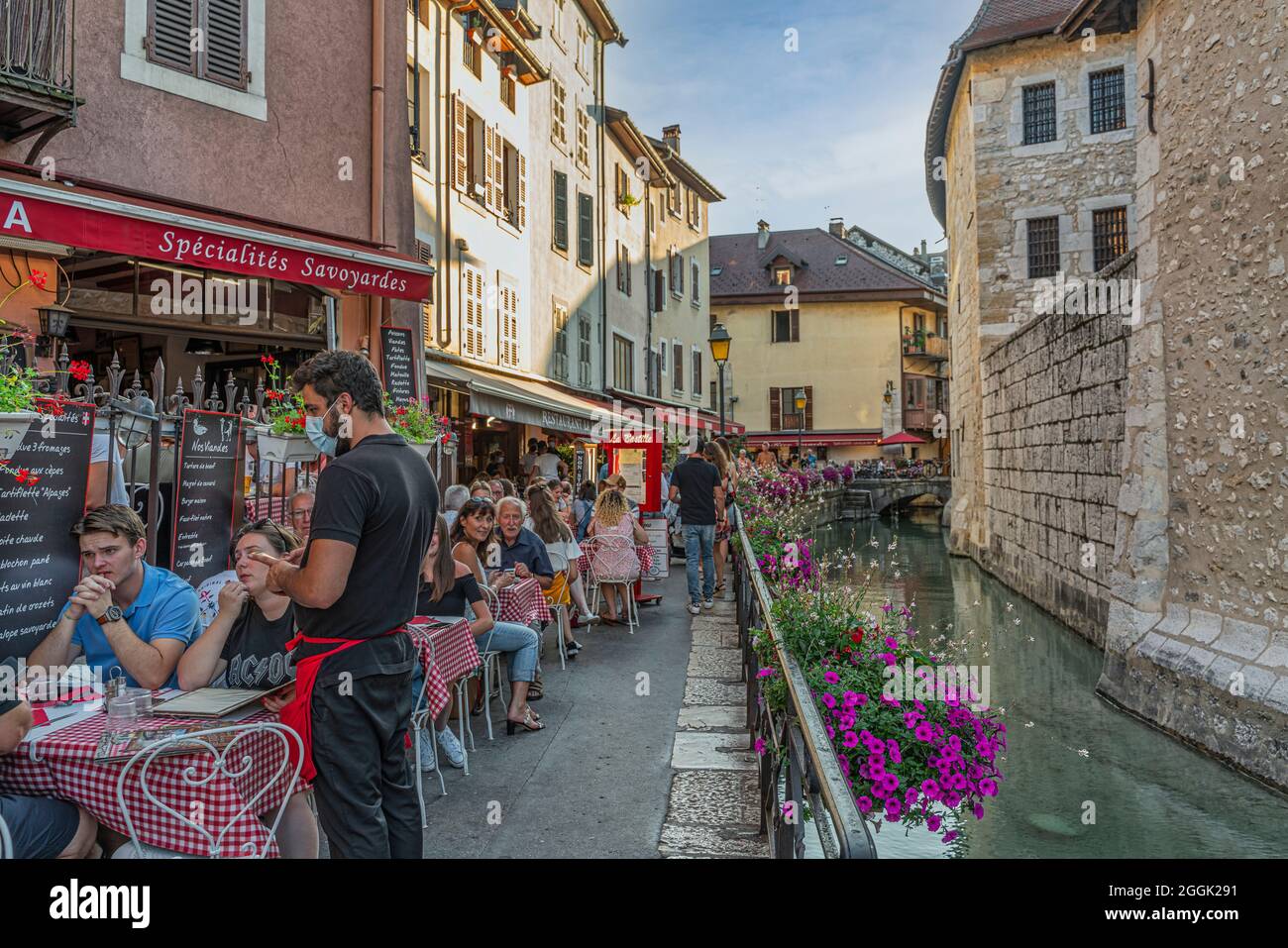 Tourists strolling through the ancient streets of the old town of ...