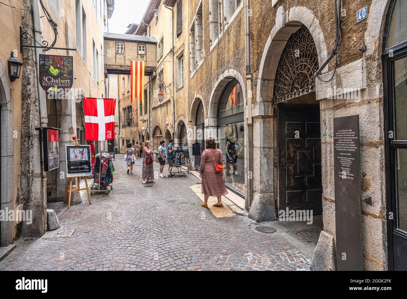 Tourists strolling in the center of the ancient city of Chambèry, with ...