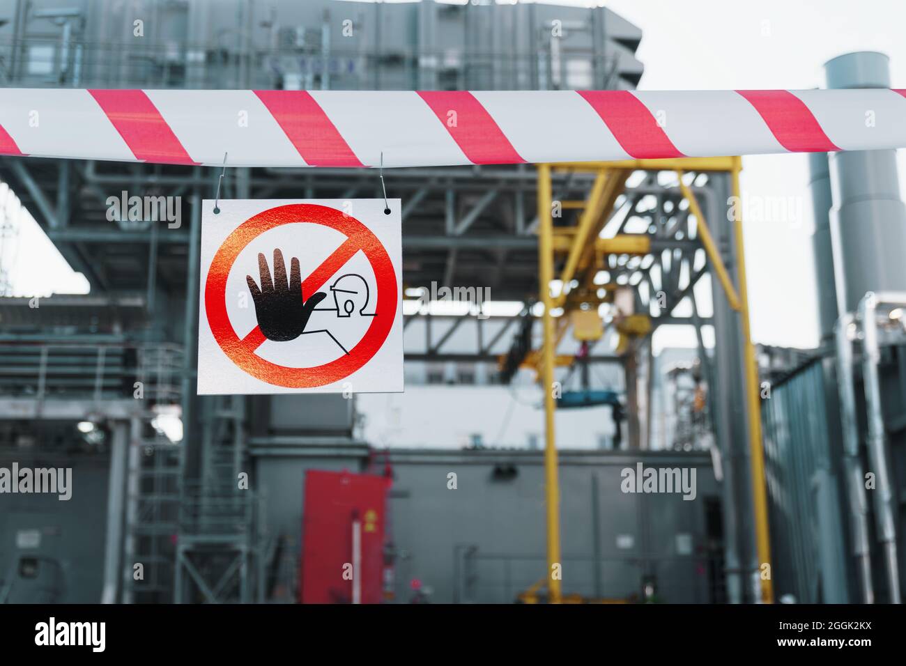 A sign prohibiting the passage of outsiders on a poster with a red and ...