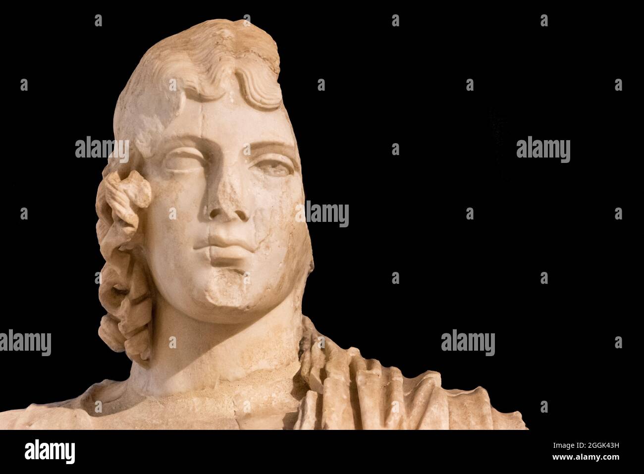 Close-up on broken face of ancient roman statue of long-haired young ...