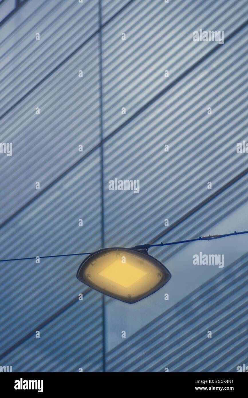 Street lighting in front of the glass facade Stock Photo - Alamy