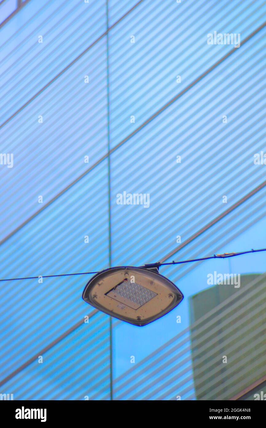 Street lighting in front of the glass facade Stock Photo - Alamy