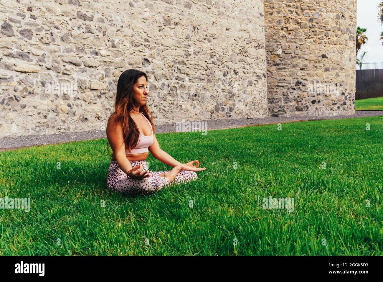 Woman doing yoga lotus flower pose Stock Photo - Alamy