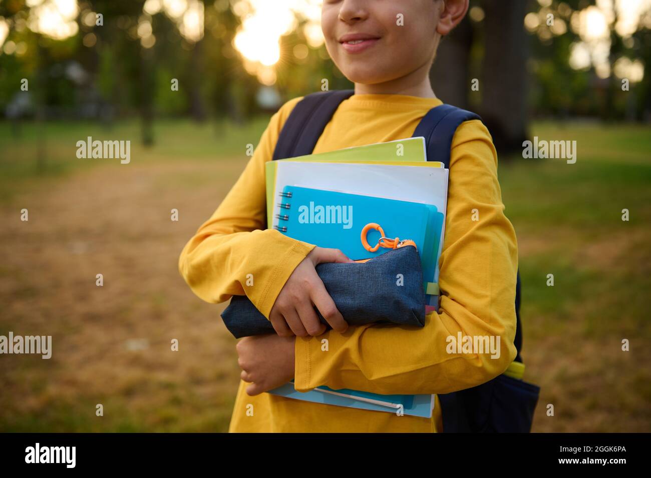 Cropped view of an adorable smiling school child boy with school ...